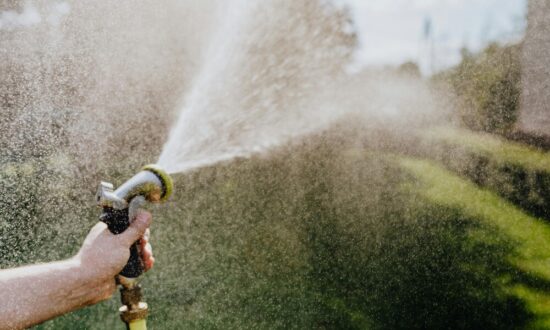 Childcare worker charged after 'spraying child with hose'